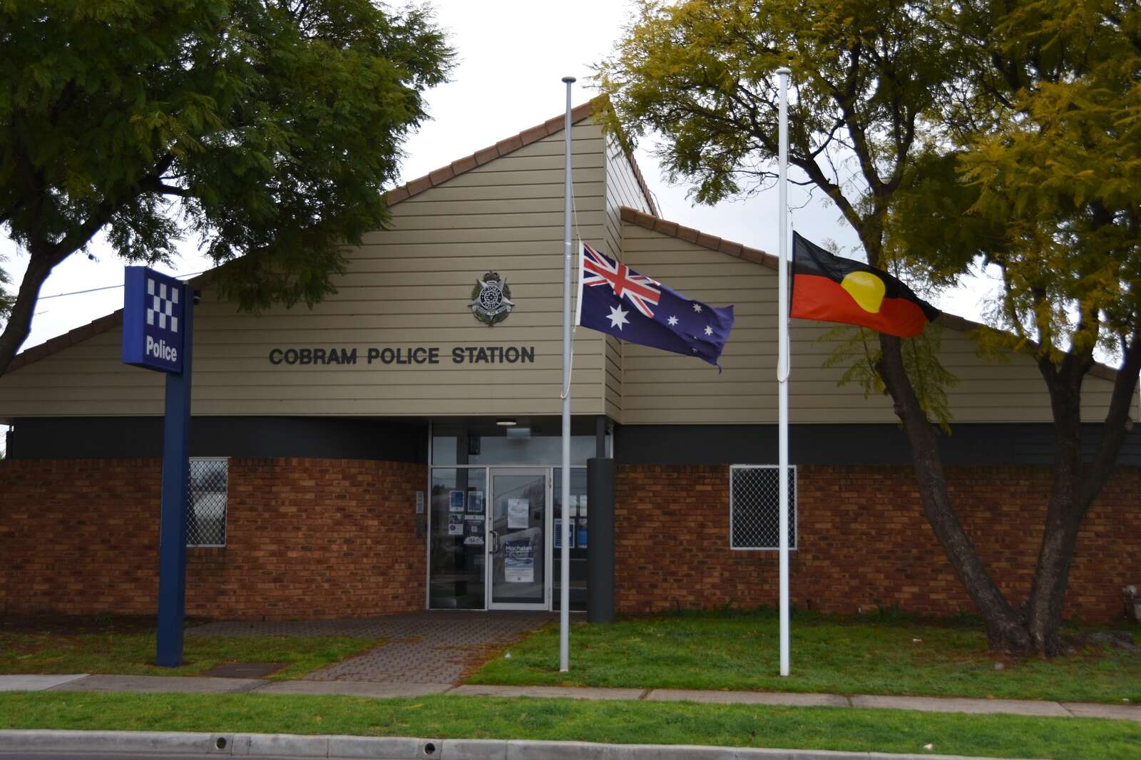 Flags fly at half mast as hunt for alleged police killer continues ...