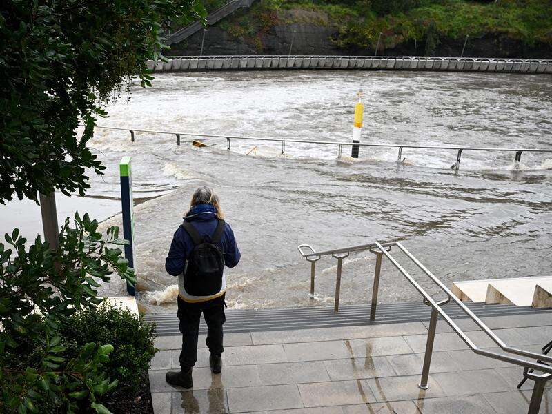 Father and son dead in river as flood threat grows | Country News